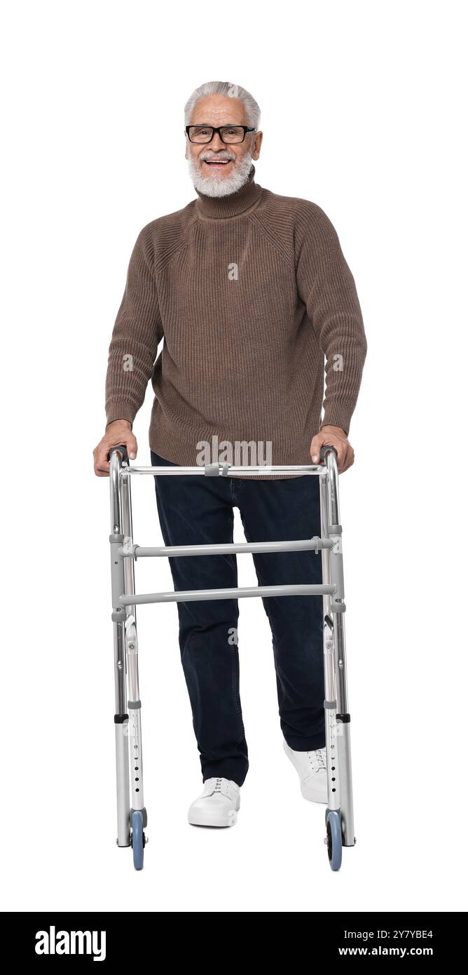 Senior man using walking frame on white background Stock Photo - Alamy