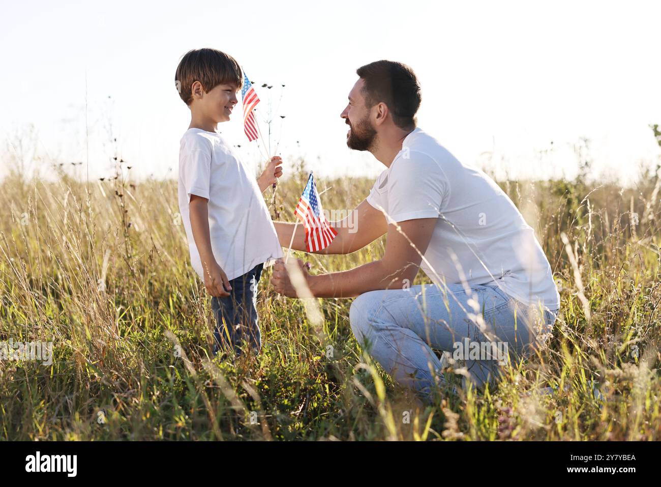 Happy father and son with flags of USA outdoors Stock Photo - Alamy