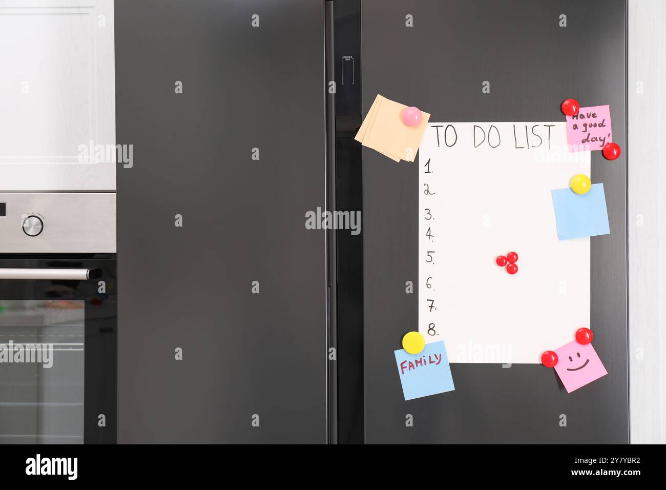 Magnetic board with to do list and notes on refrigerator in kitchen ...