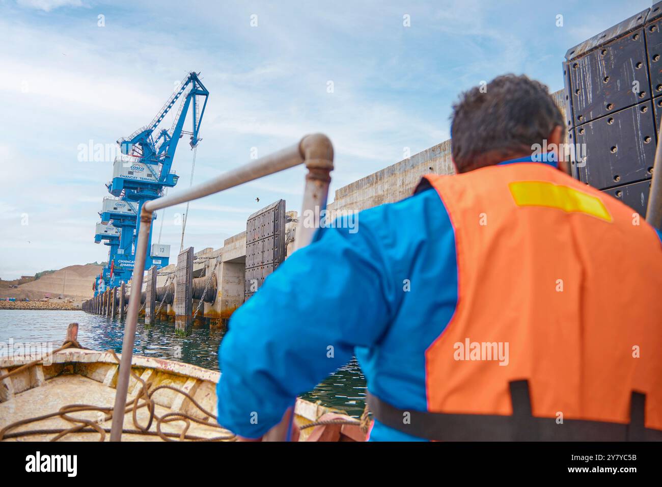 Chancay, Lima. Peru, September 20 2024:A man in a life jacket watches a ...