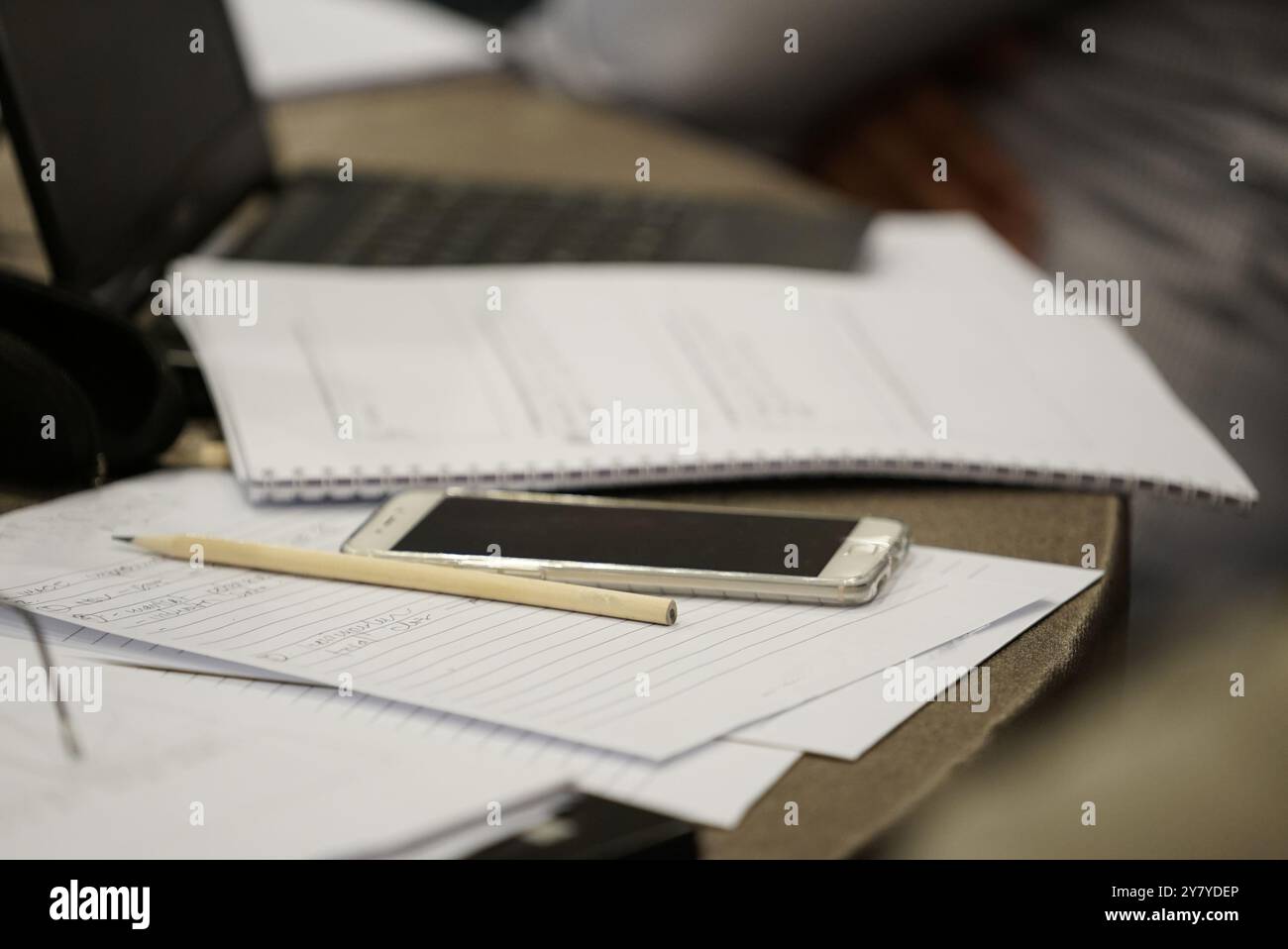 Table with paper pencil and handphone crowded in meeting room office ...