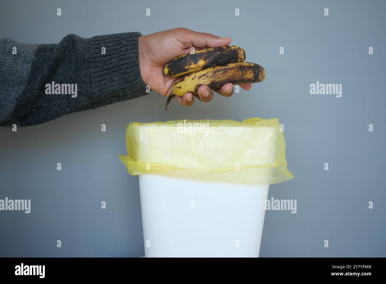 Properly Discarding Overripe Bananas into the Trash Bin to Maintain ...