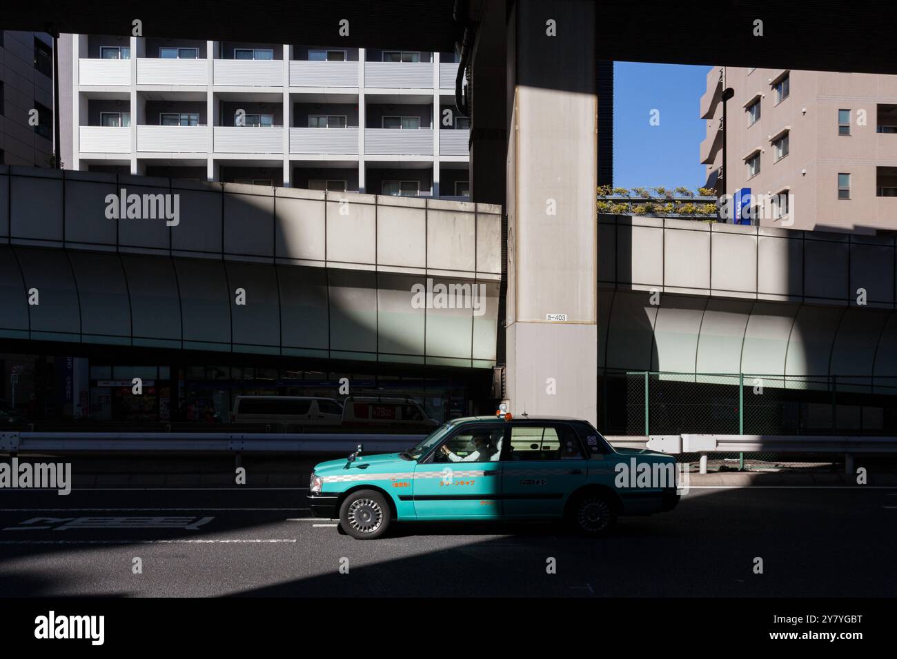 A blue taxi under expressway overpasses in Sangenjaya, Tokyo, Japan ...