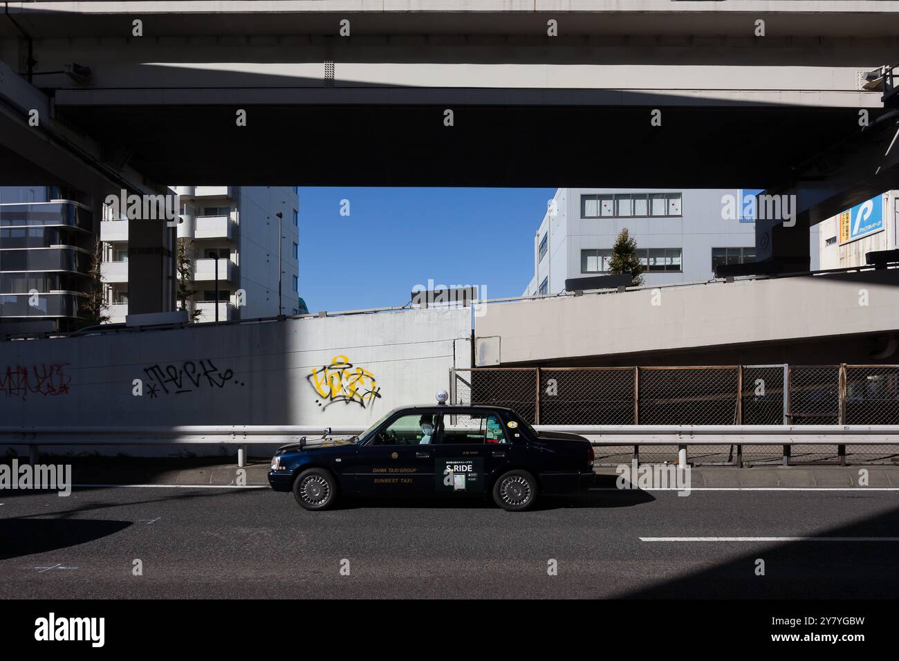 A black taxi under expressway overpasses in Sangenjaya, Tokyo, Japan ...