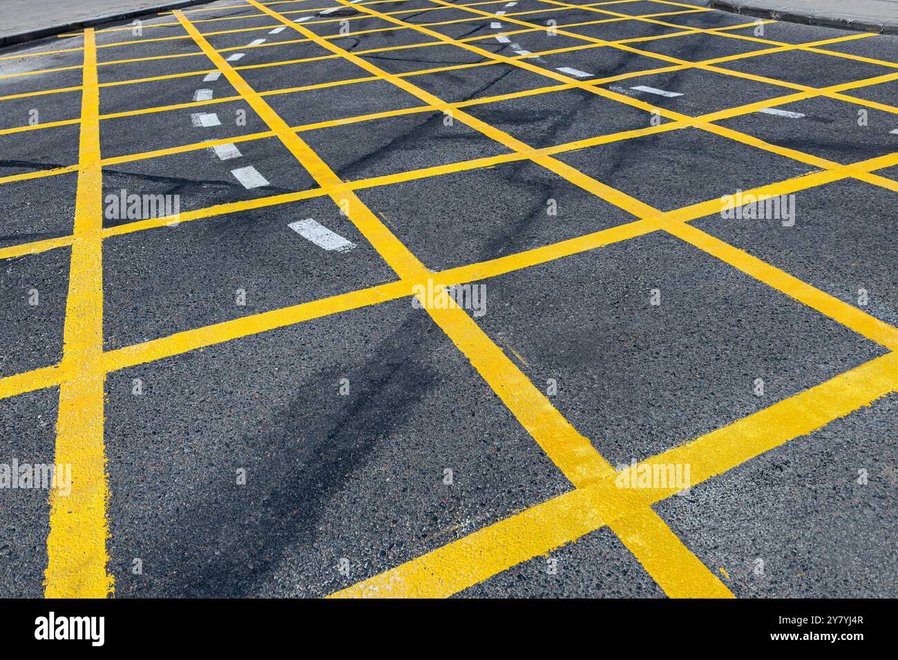 prohibition of stopping a cars. yellow grid line on city crossroad ...