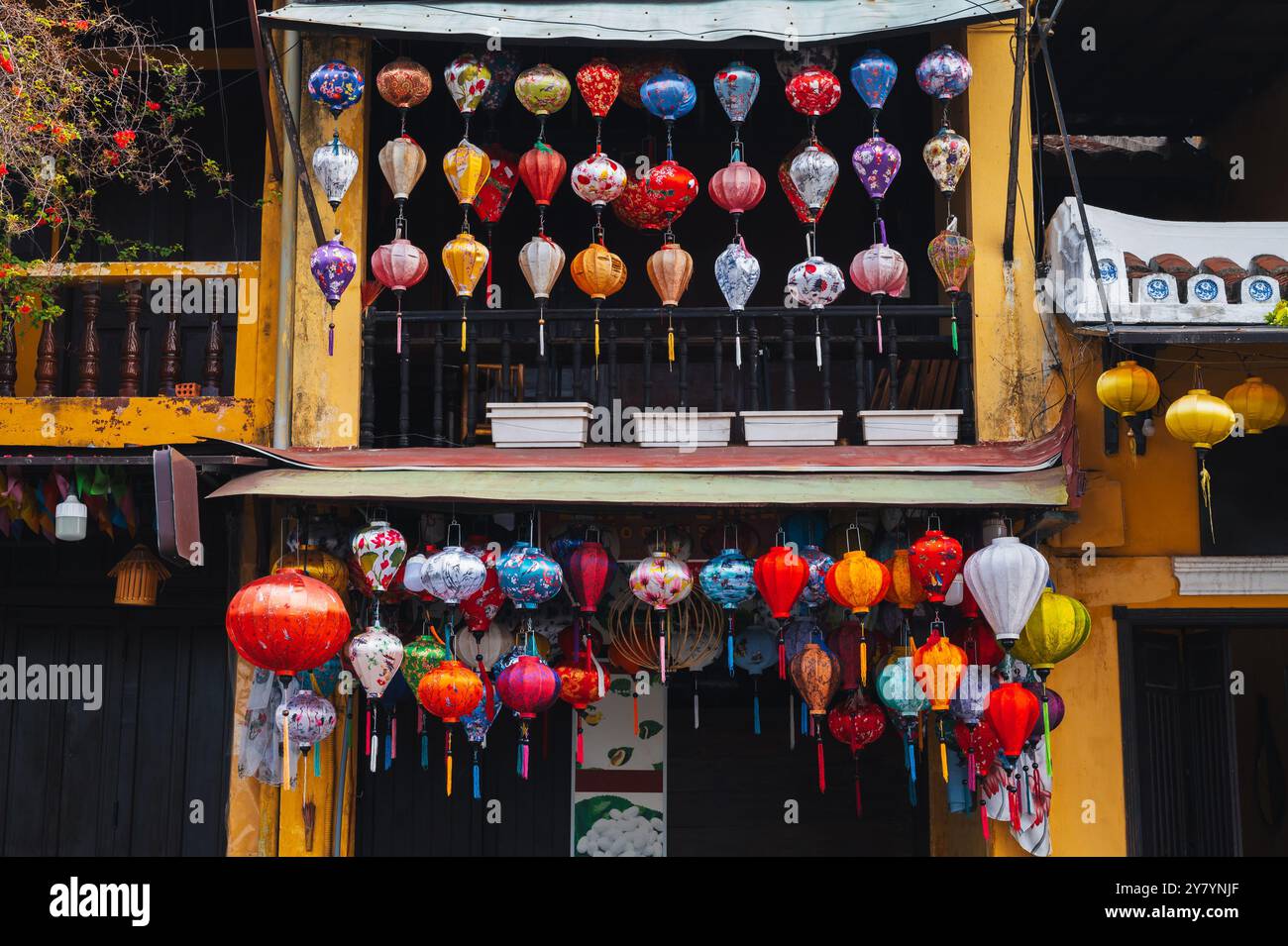 colorful silk Chinese lanterns decorate the wall of a traditional Asian ...