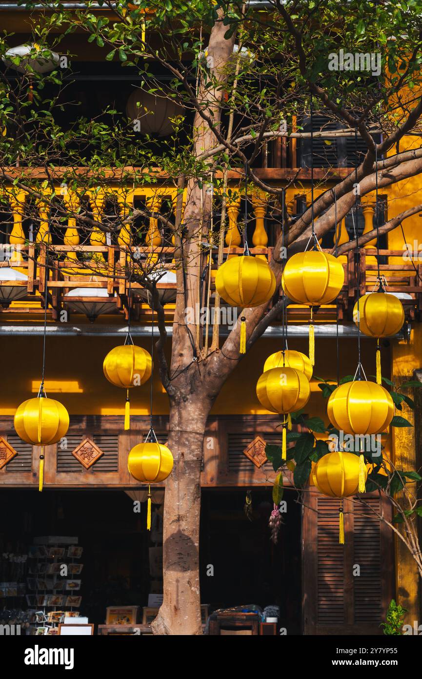 facade of an ancient Asian house decorated with yellow hanging Chinese ...