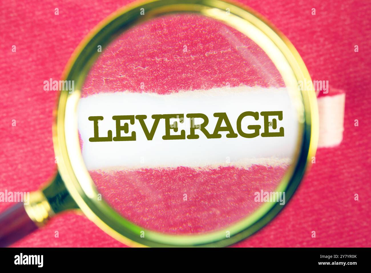 LEVERAGE text written on white paper through a magnifying glass under a ...