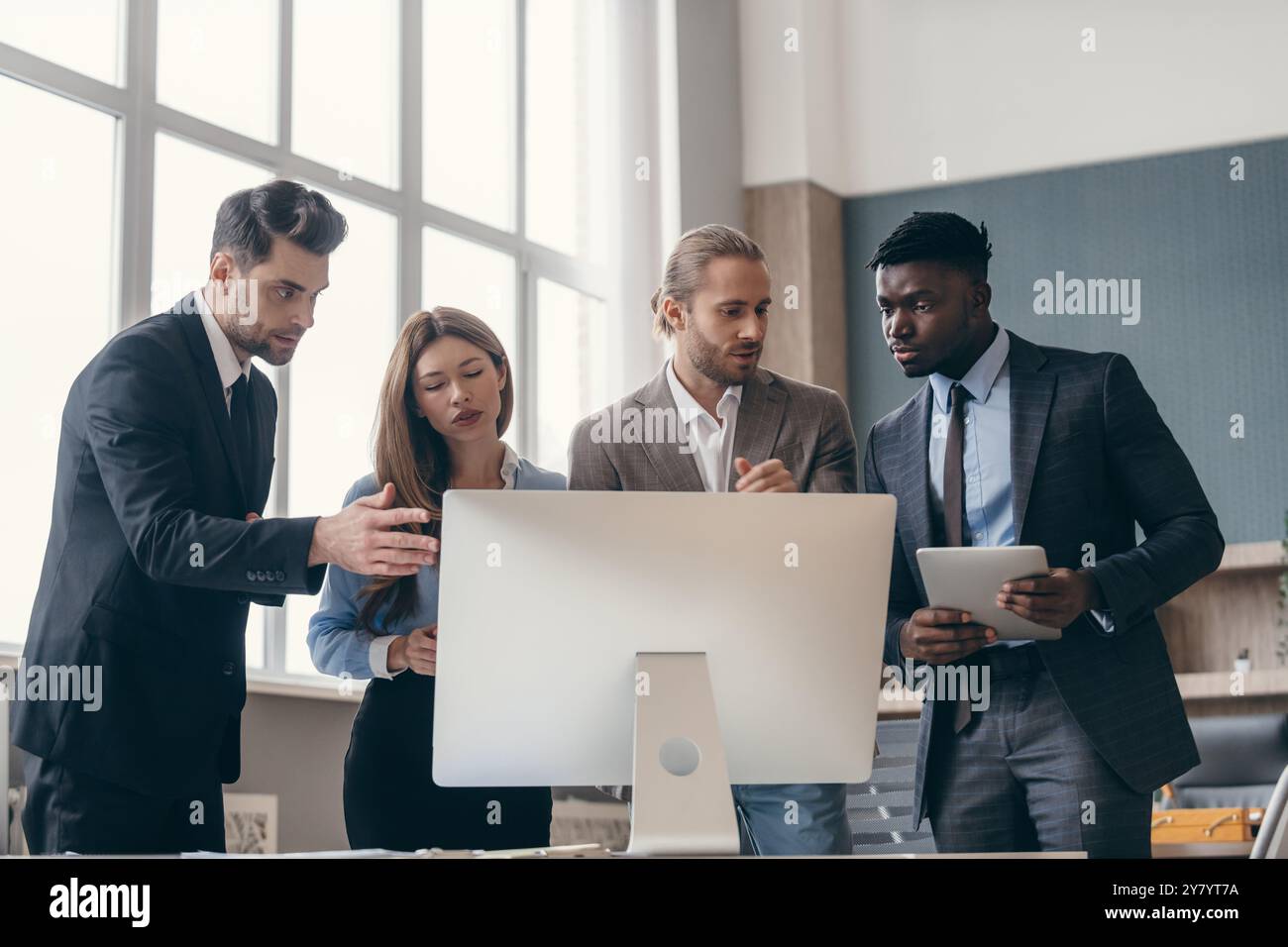 Group of confident business people having a discussion while looking at ...