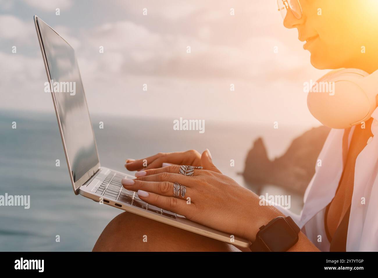 Woman, Laptop, Beach - Working remotely on laptop at beach during ...