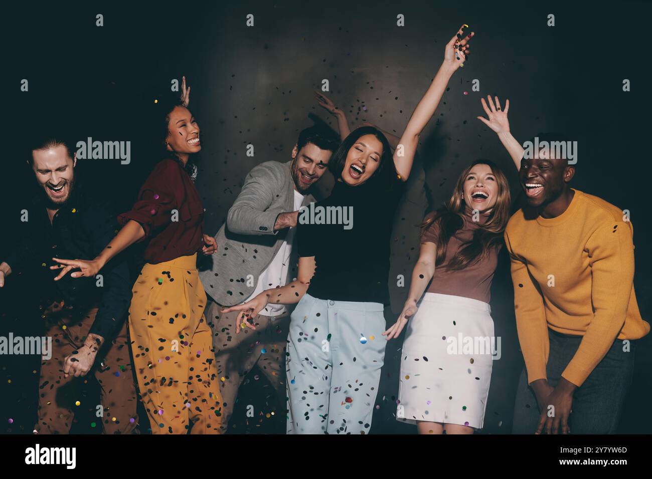 Group of joyful young friends dancing and having fun in night club ...