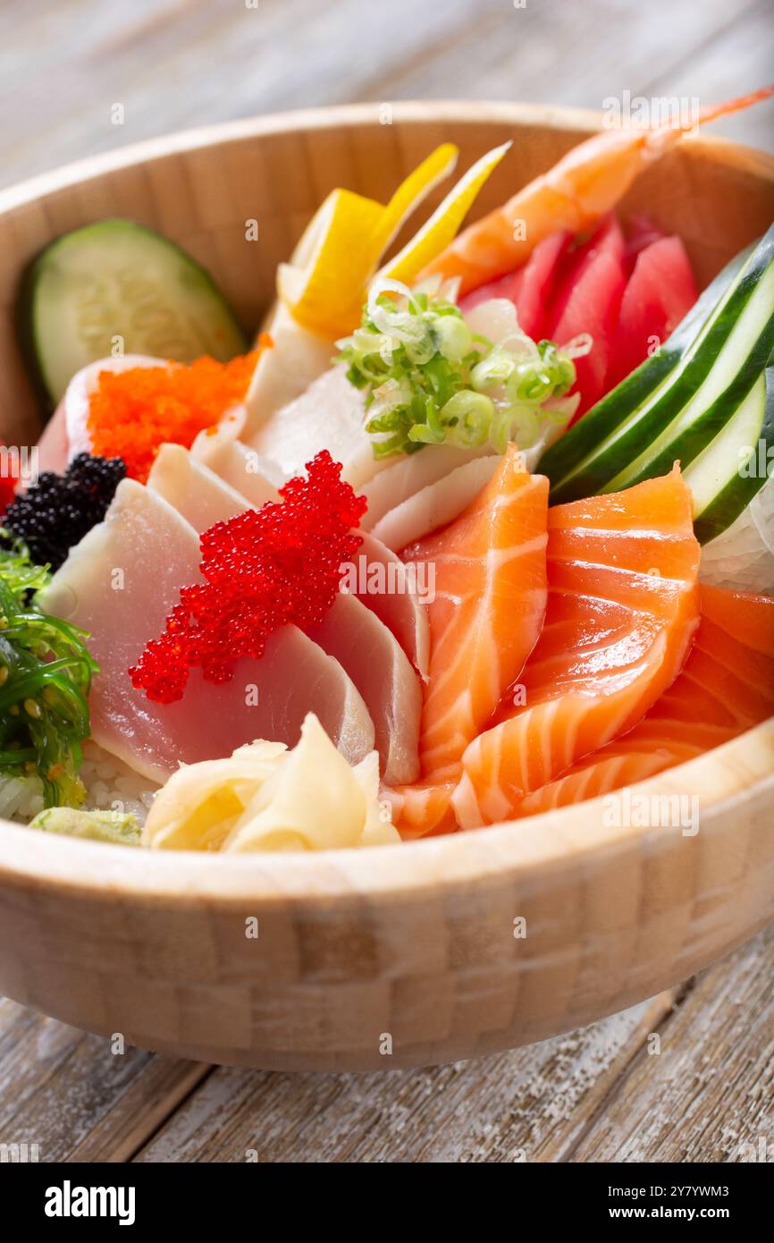 A view of a colorful sashimi bowl, featuring cuts of salmon, tuna, and ...