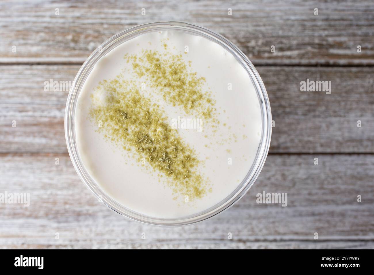 A top down view of a foamy Taiwanese boba tea drink featuring a dash of ...