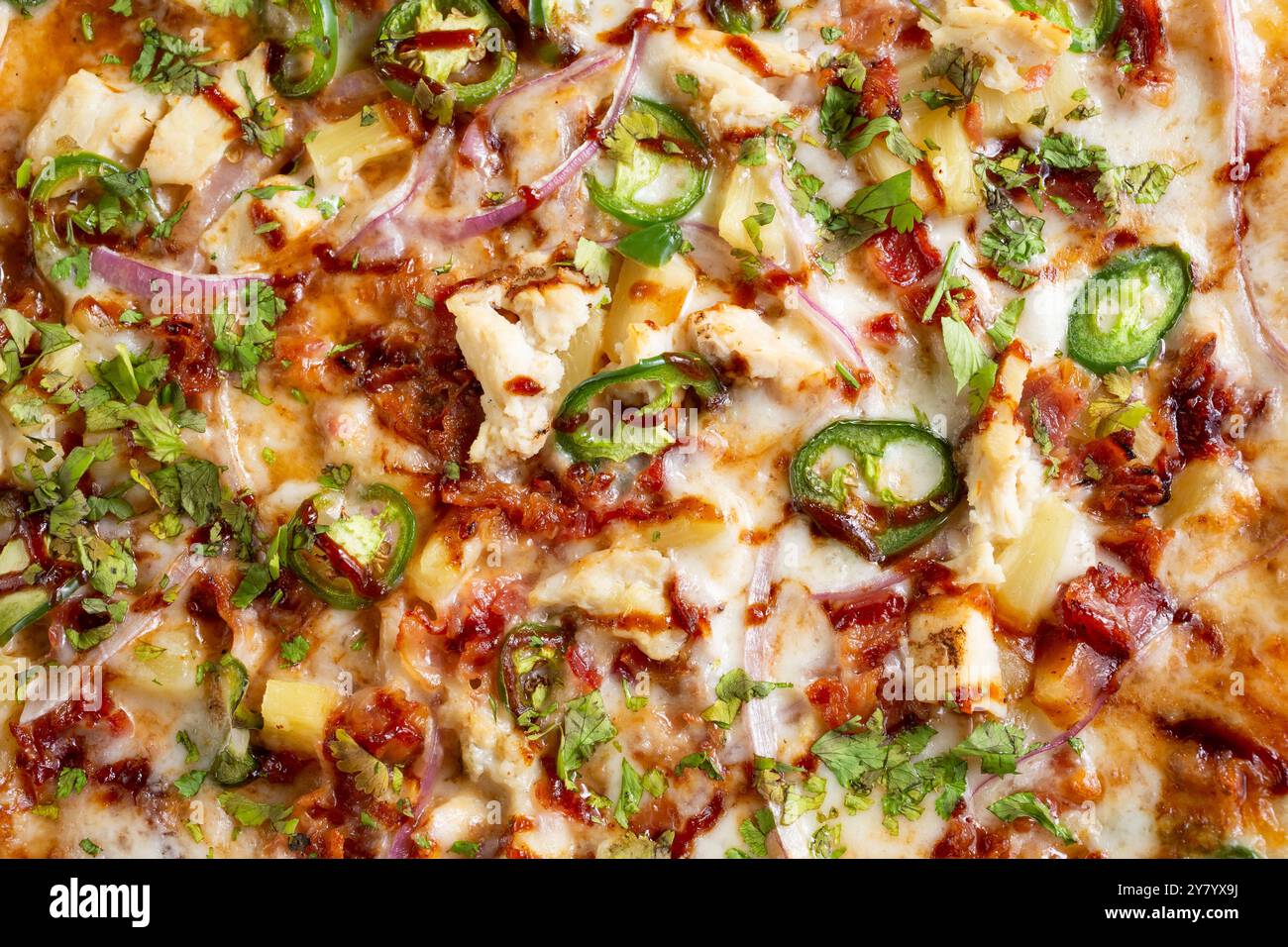 A top down view of a barbecue chicken and jalapeno pizza, as a ...
