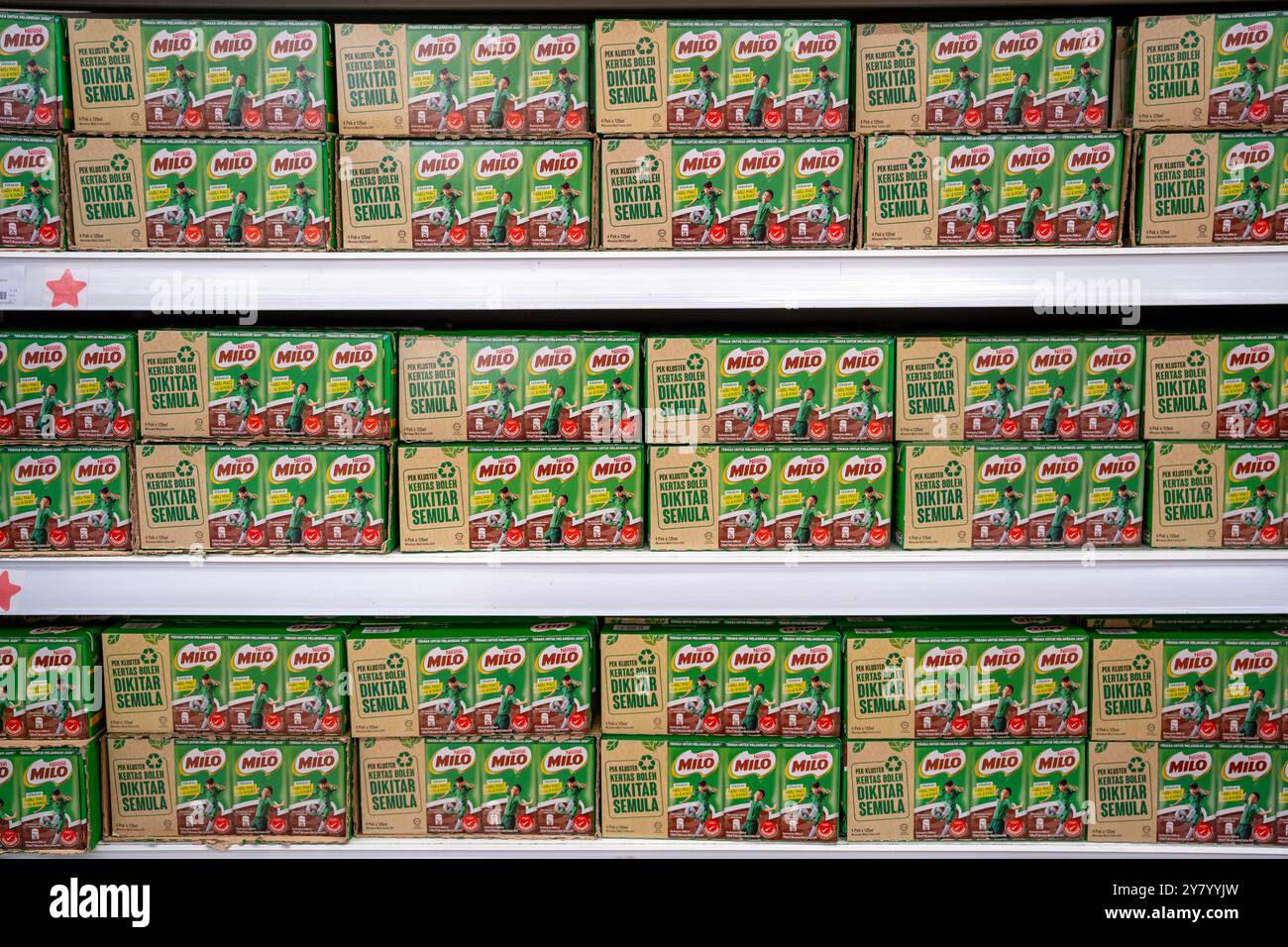 A neatly arranged shelf filled with boxes of Milo chocolate malt drink ...