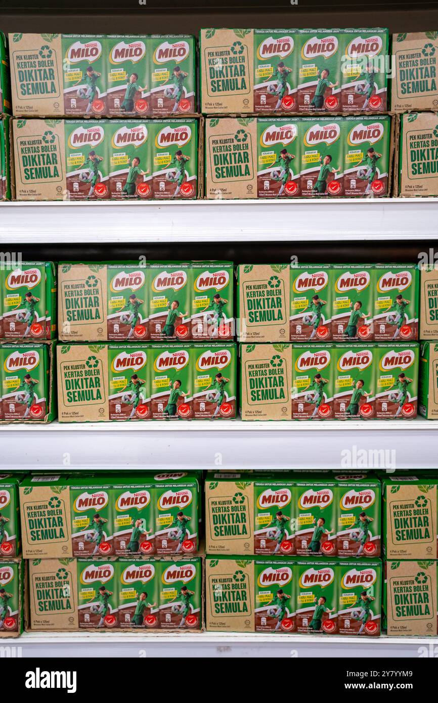 A neatly arranged shelf filled with boxes of Milo chocolate malt drink ...