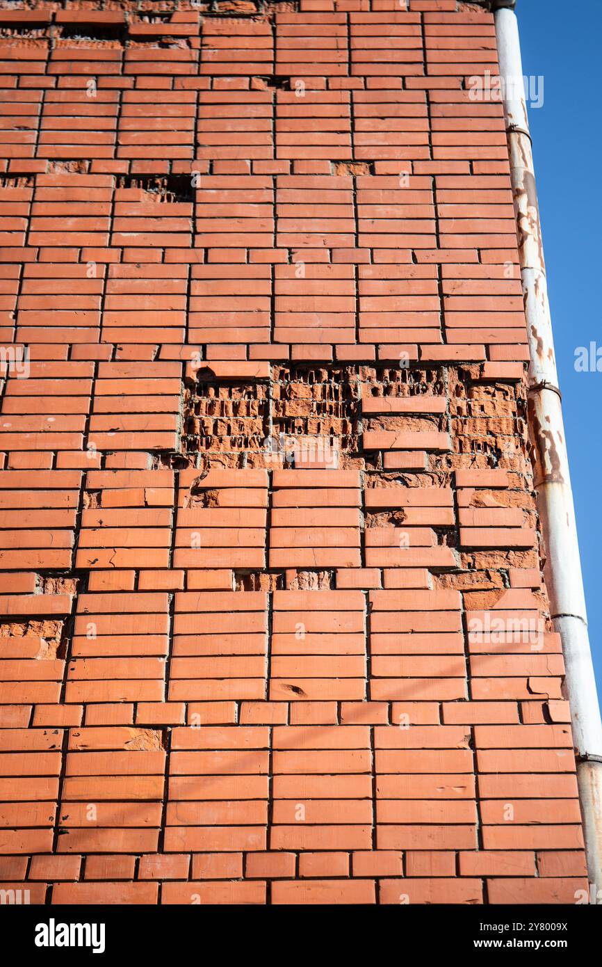Red brick facade. Water drain pipe and water damage Stock Photo - Alamy