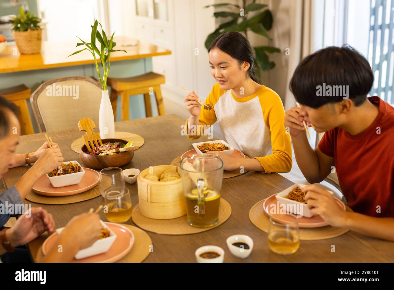 At home, Eating together, asian family enjoying meal with chopsticks at dining table Stock Photo ...