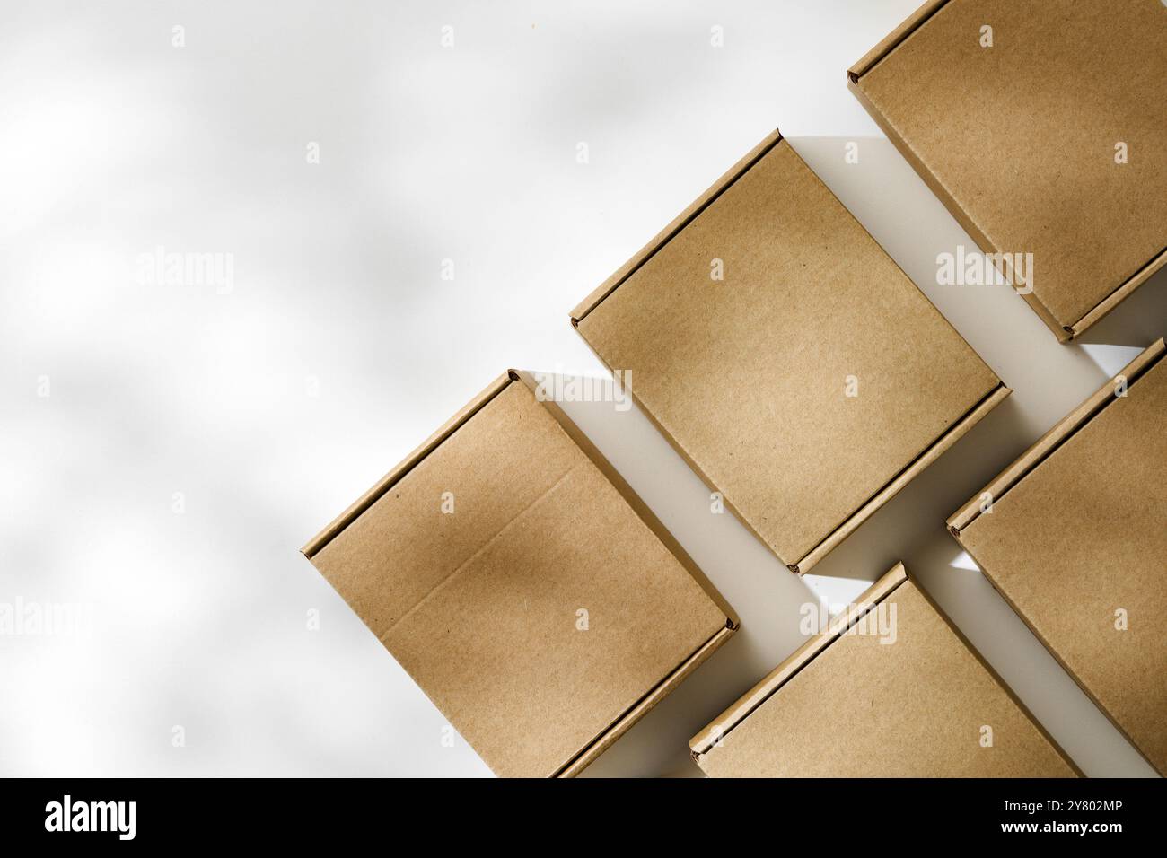 Brown cardboard boxes arranged on a neutral background in a warehouse ...
