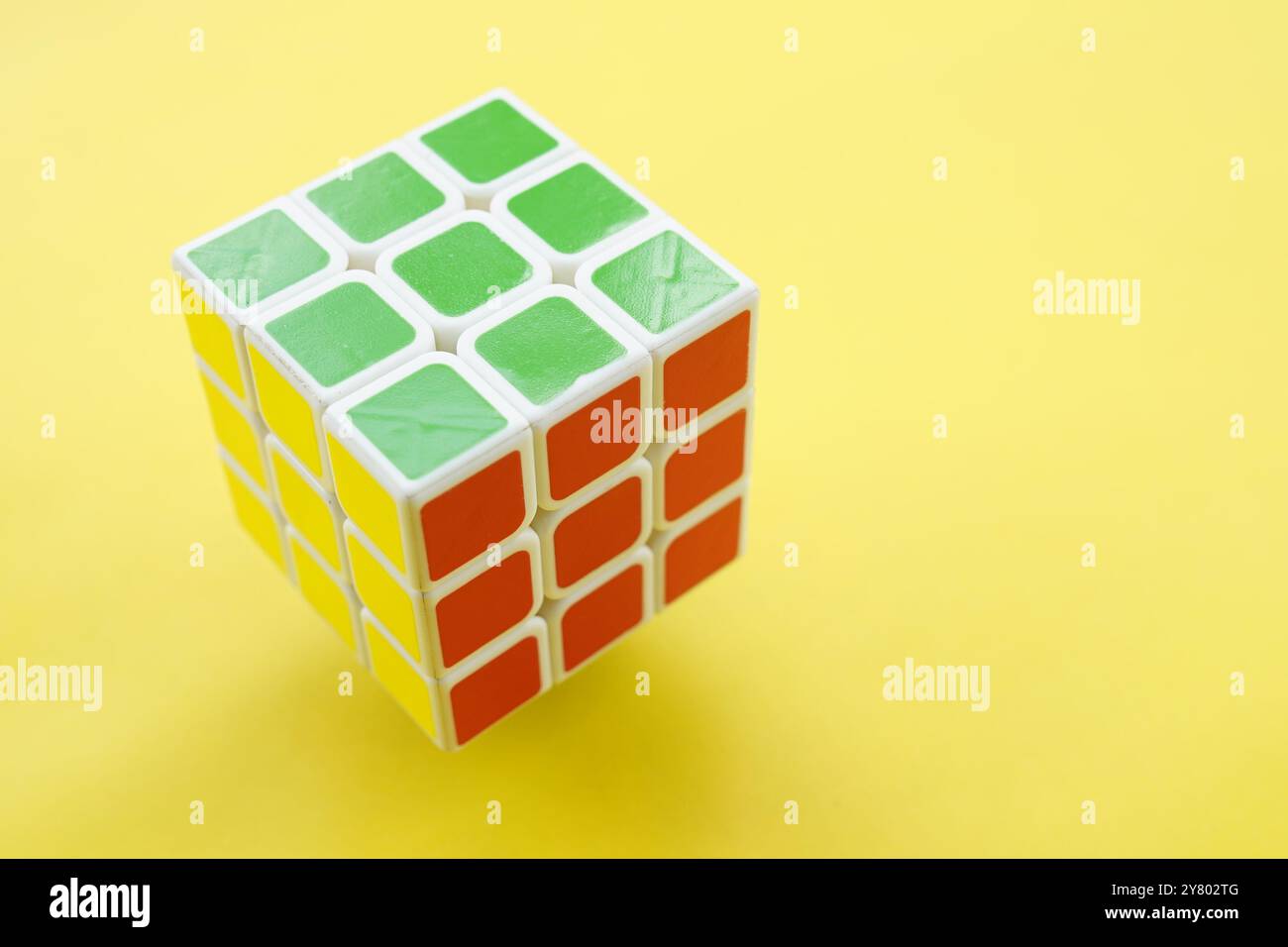 colorful rubik's cube on yellow background Stock Photo - Alamy