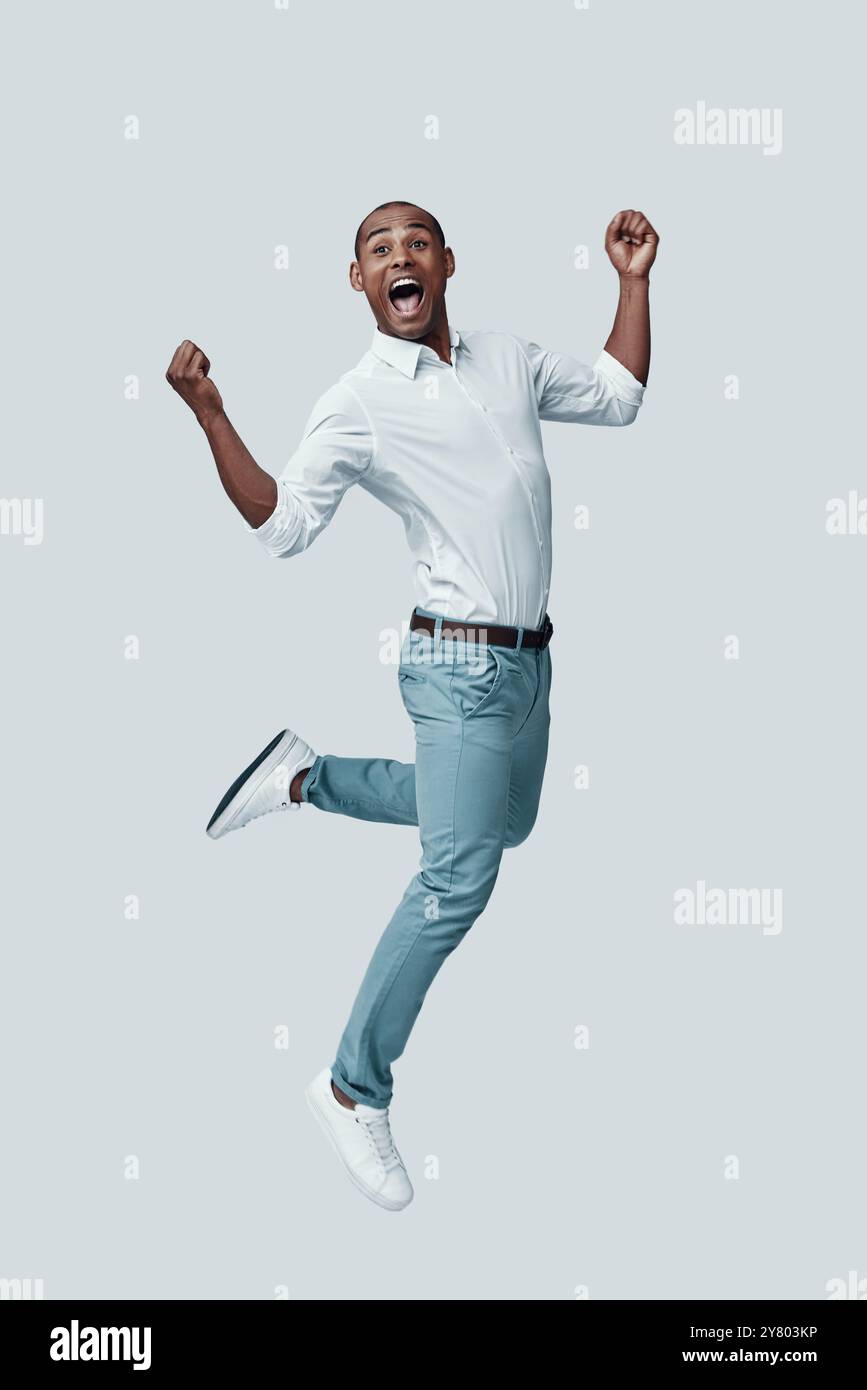 Playful. Handsome young African man making a face while hovering ...