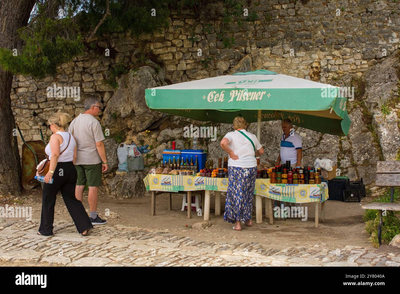 Berat, Albania - June 2nd 2024. Visitors browse souvenir food items and ...