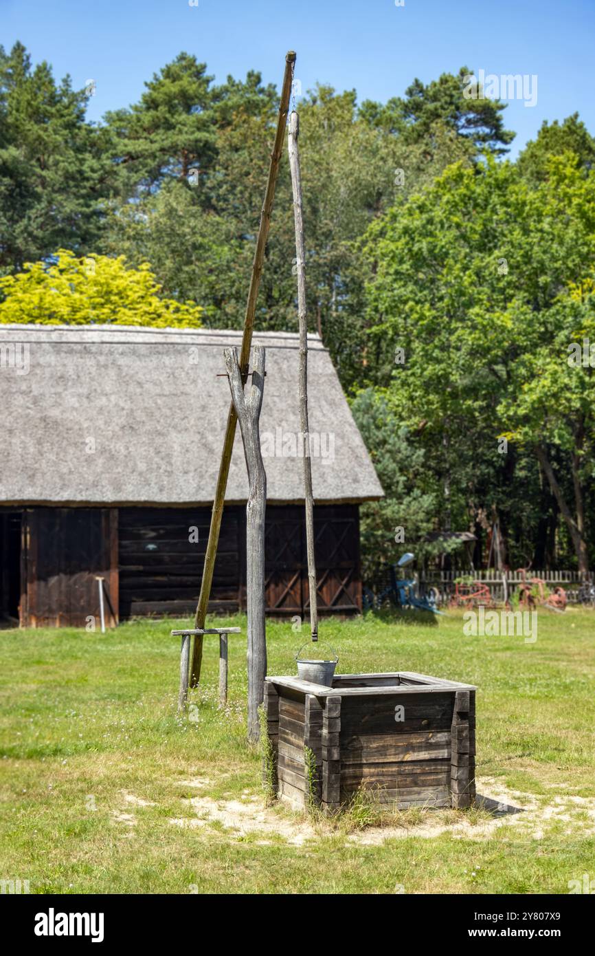 Old wooden well with a pulley in the village Stock Photo - Alamy