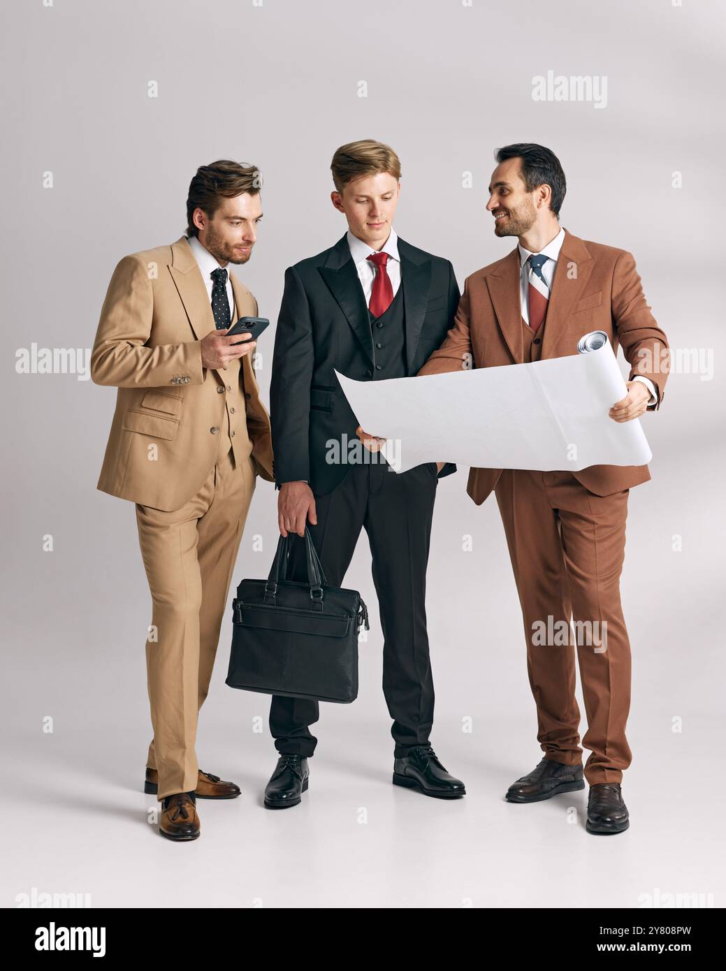 Business team reviewing plans. Group of men dressed fashion formal ...