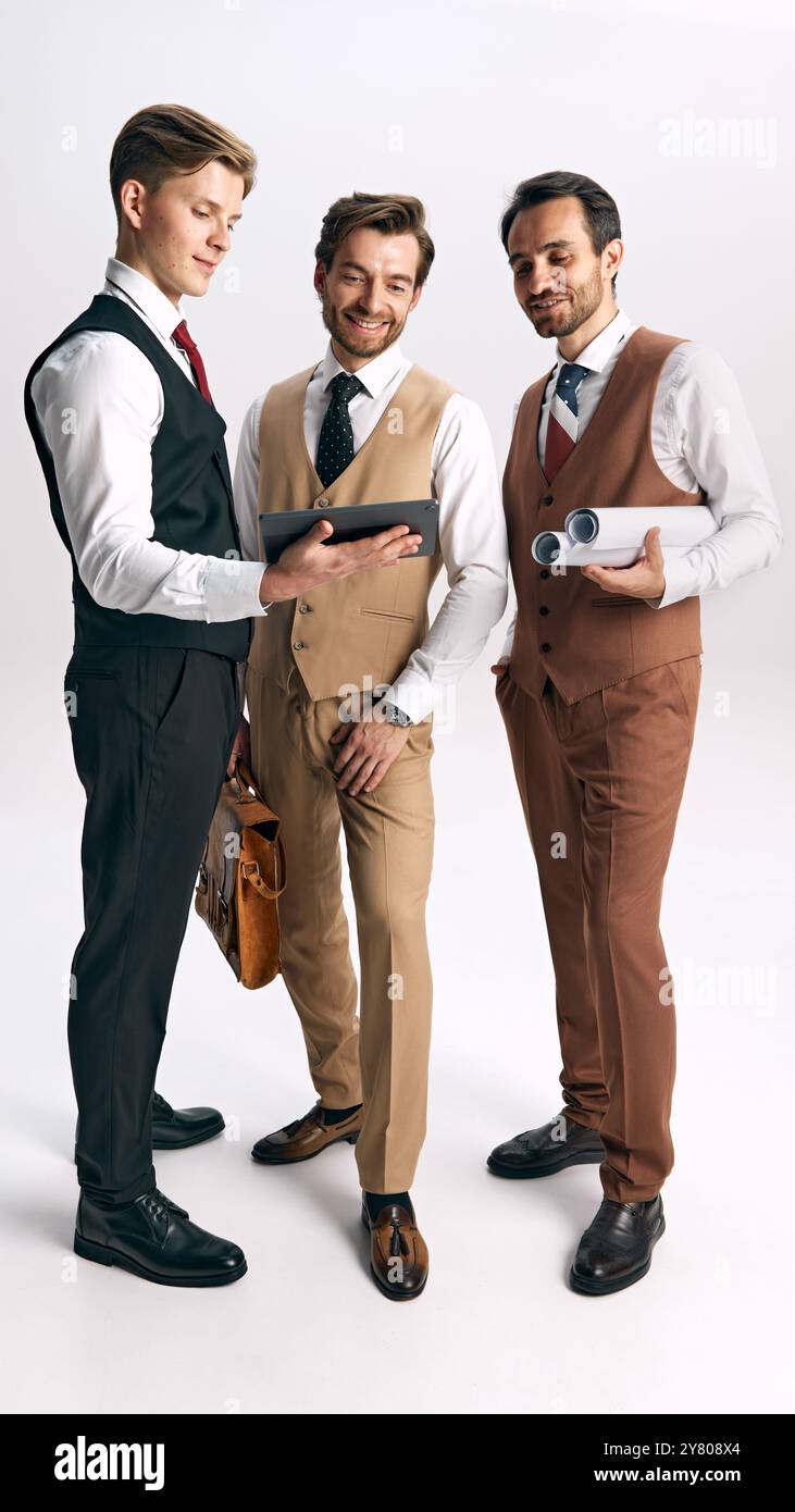 Group of young men, dressed formal wear in light discussion, focused on ...