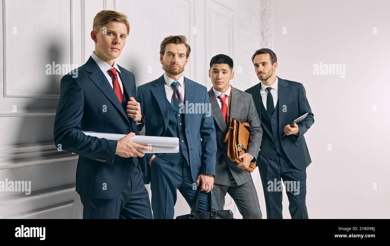 Businessmen hold important work materials, posing in formal attire and ...
