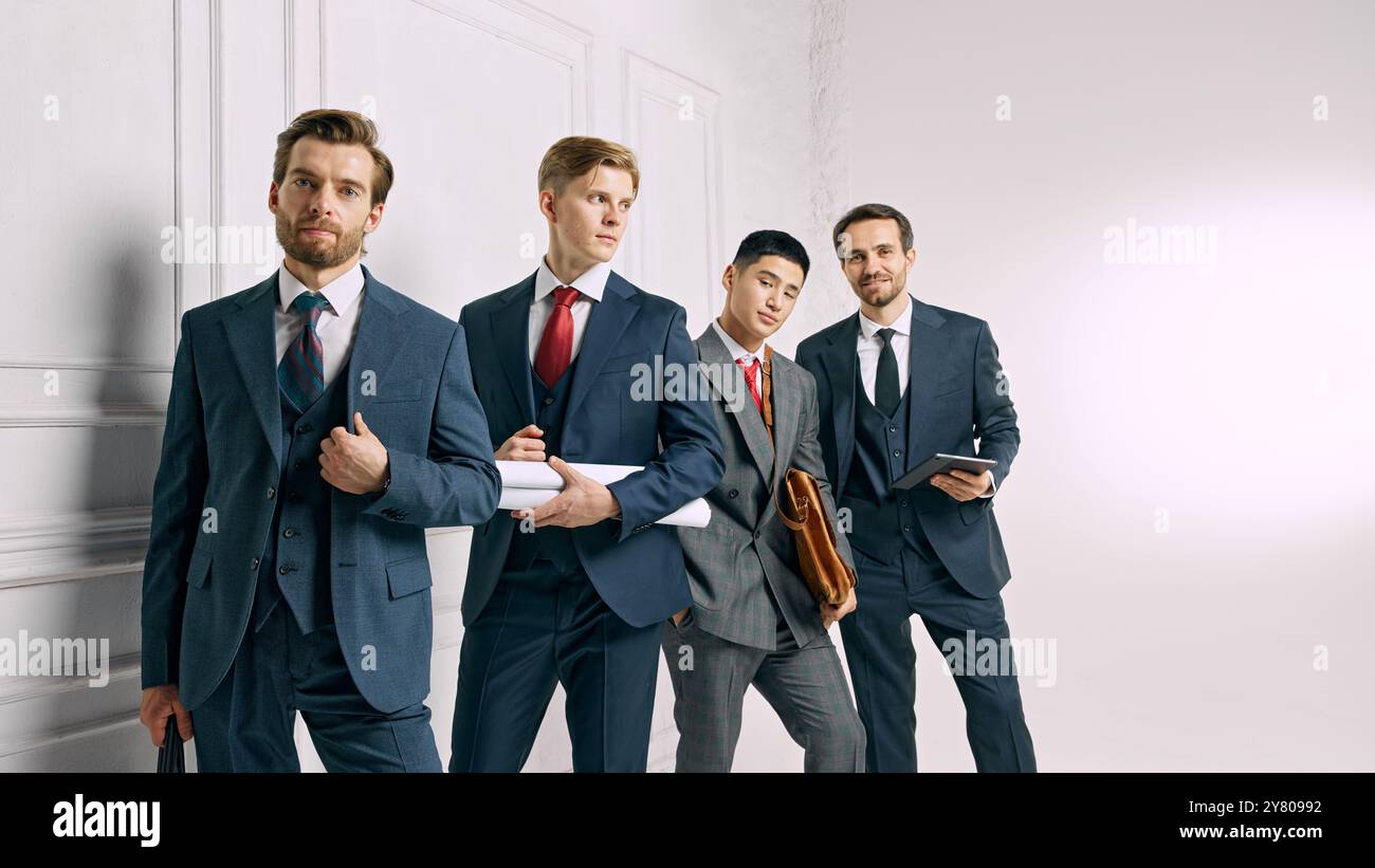The team poses confidently against white studio background, each ...