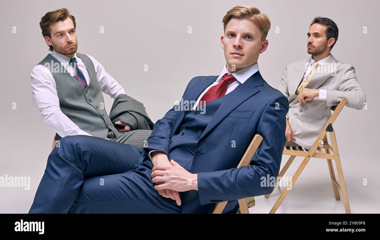 Close-up of confident businessmen in relaxed pose seating, and leader ...