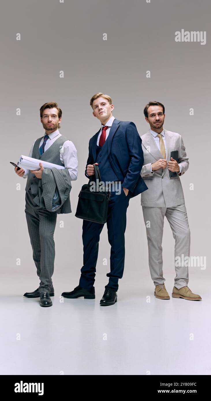 Portrait of young men, dressed classy outfits, team ready for business ...