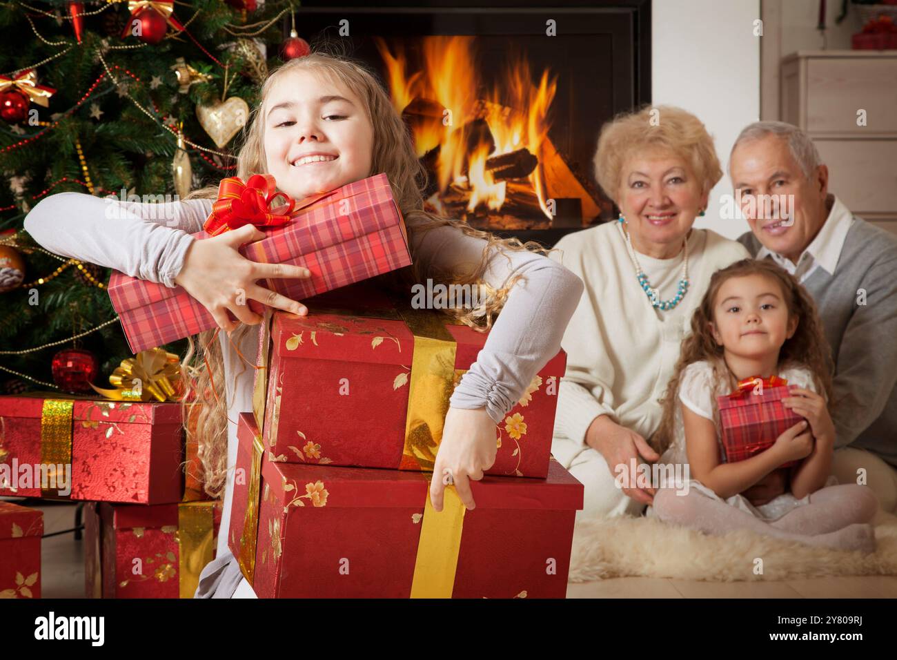 Focus on the happy little girl getting Christmas presents Stock Photo ...