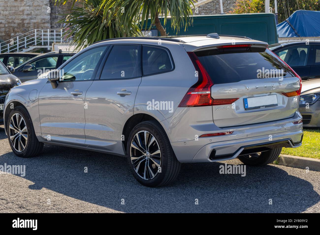 Modern silver volvo xc60 plug in hybrid suv parked on a city street ...