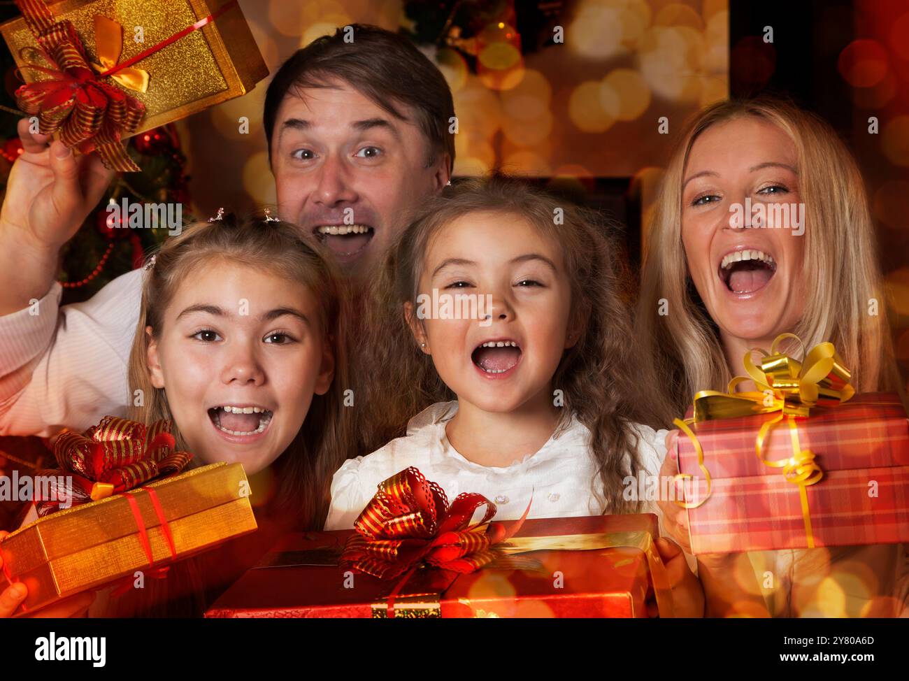 Young beautiful family having fun at Christmas Stock Photo - Alamy