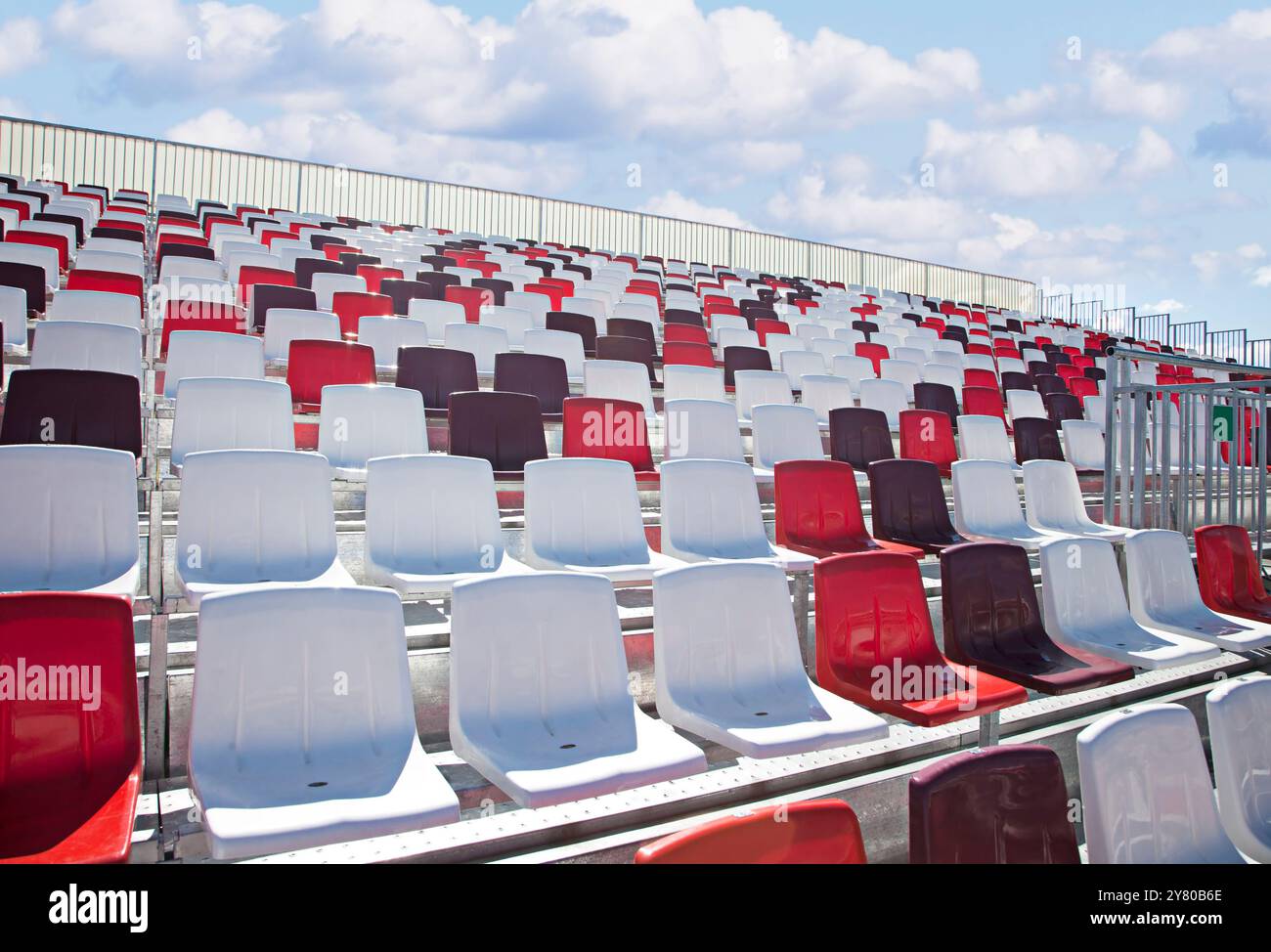 Colorful empty plastic seats on new modern concrete stadium tribune ...