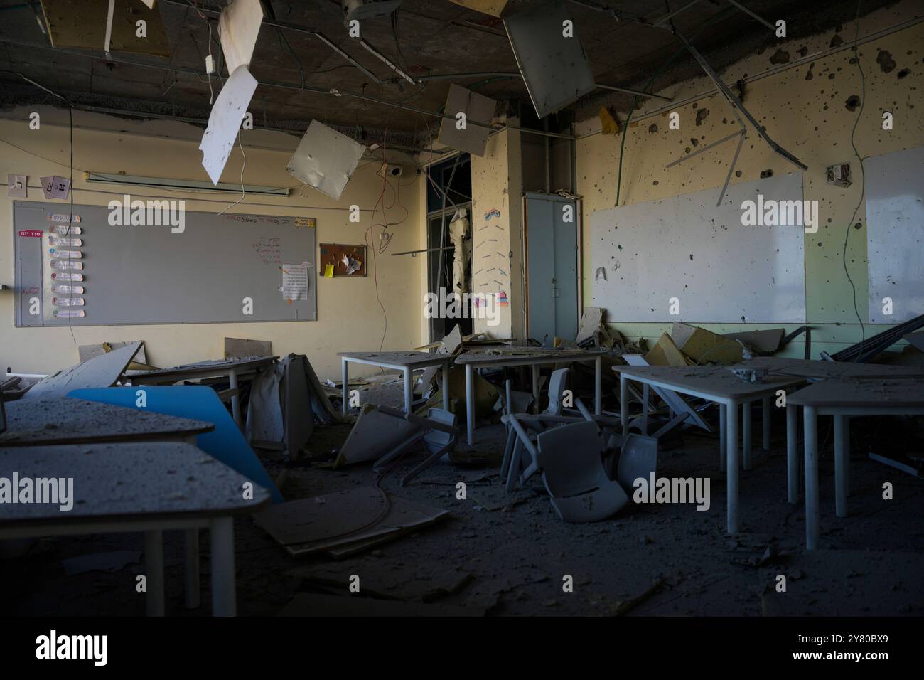 A damaged classroom is seen in a school building after it was hit in ...