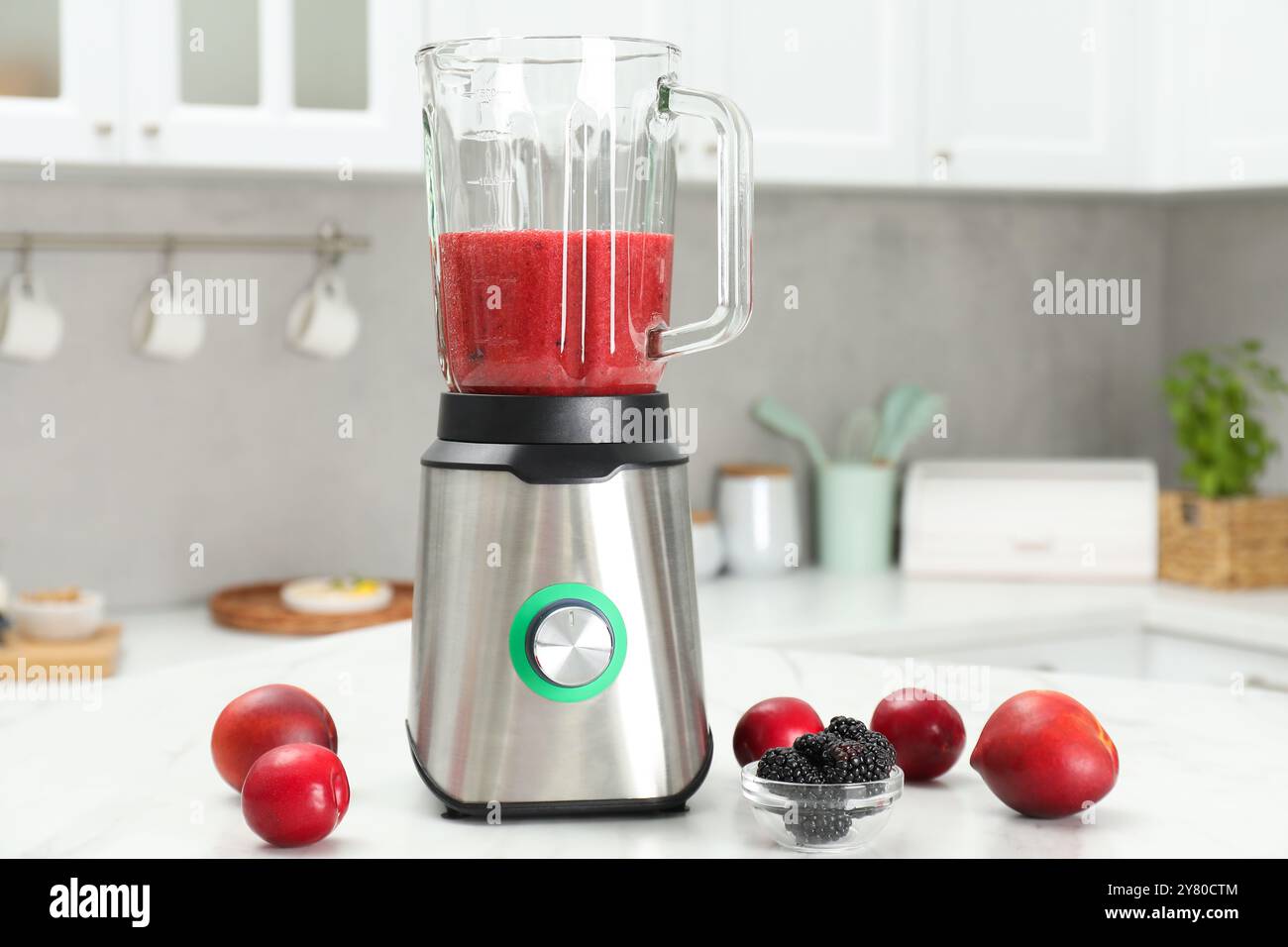 Blender with mixture of ingredients, fresh berries and fruits on white ...