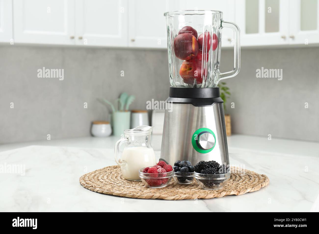 Blender and fresh ingredients on white marble table in kitchen Stock ...