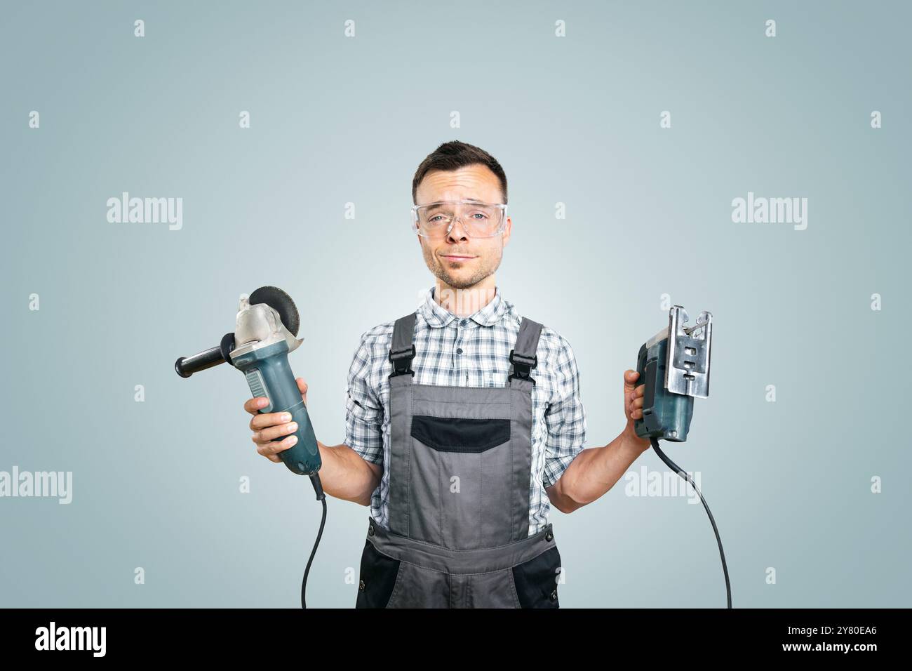 Portrait of a Worker Holding Power Tools in Both Hands Stock Photo - Alamy