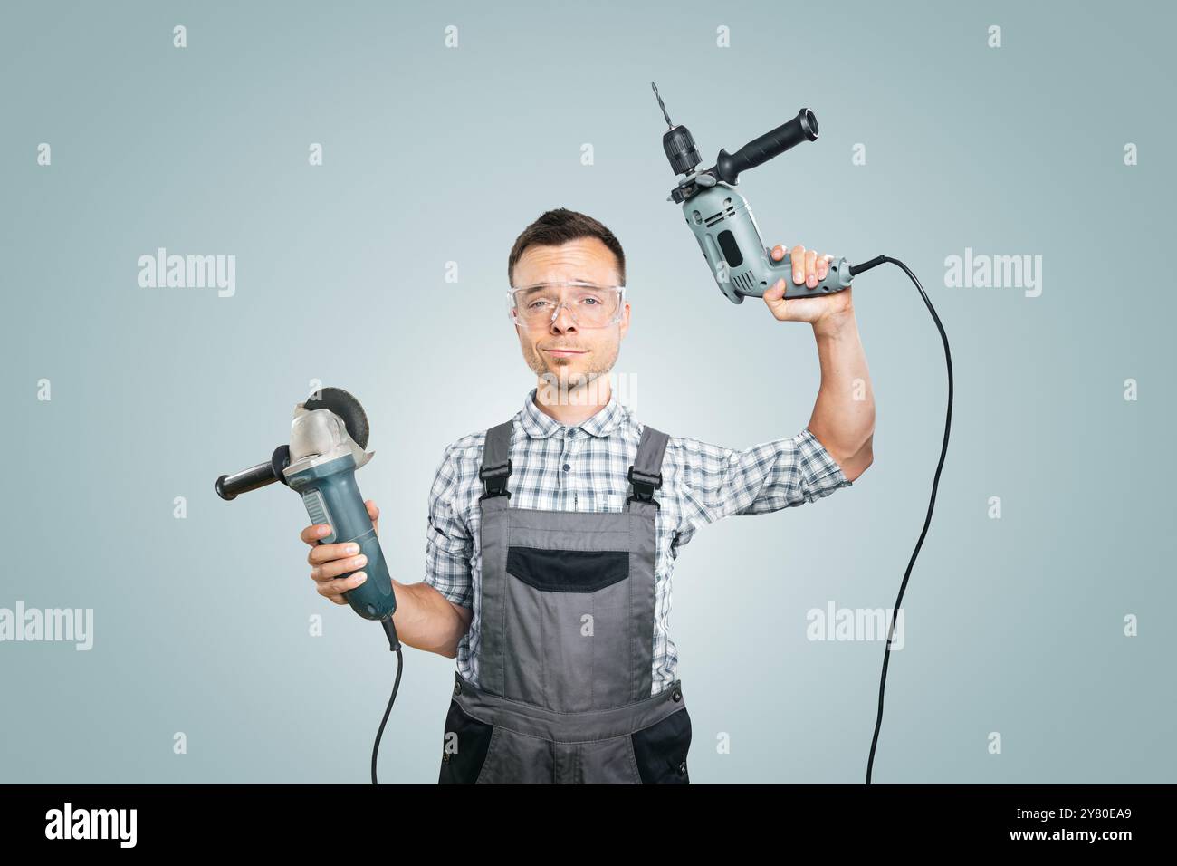 Portrait of a Handyman Holding Power Tools in Both Hands Stock Photo ...
