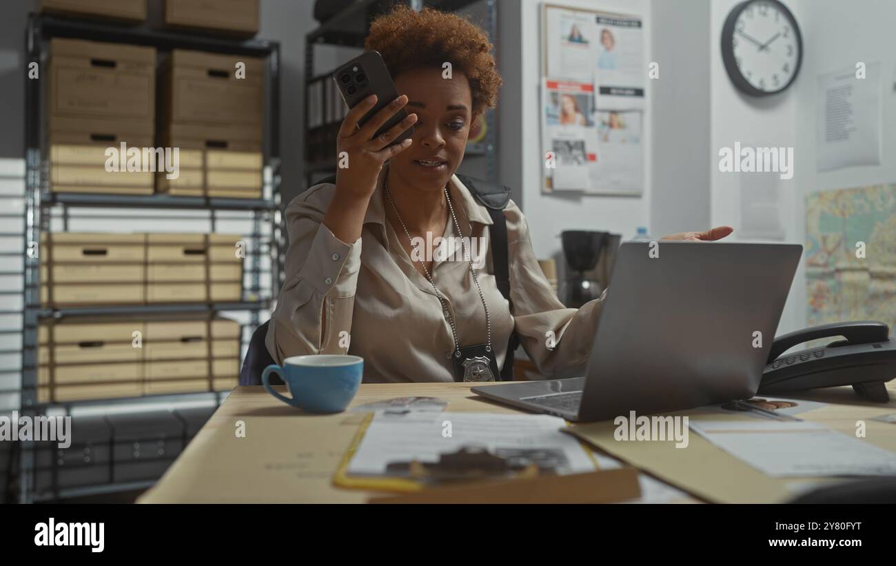 African american female detective working and making phone call in ...