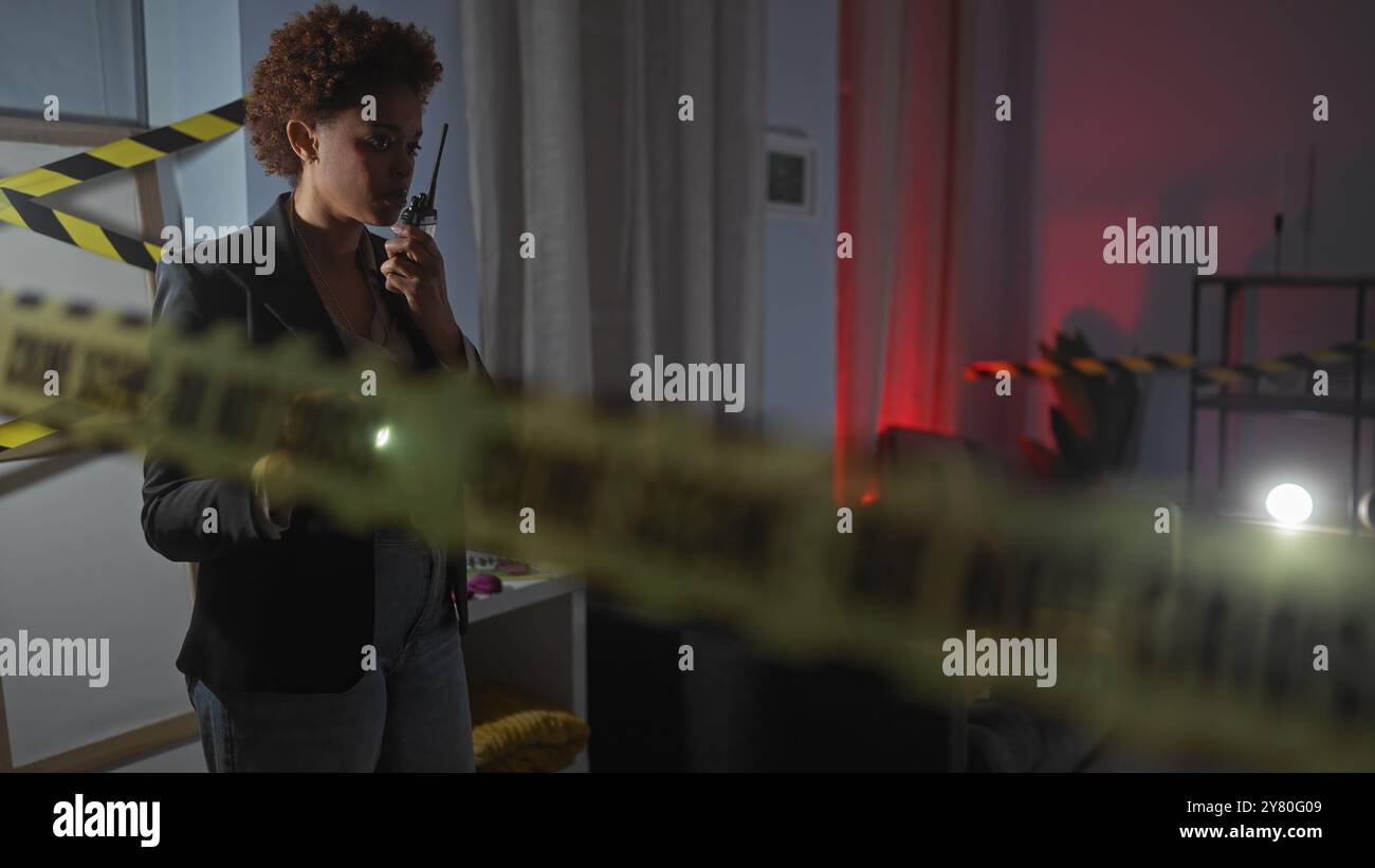 African american woman detective with radio in a crime scene room with ...