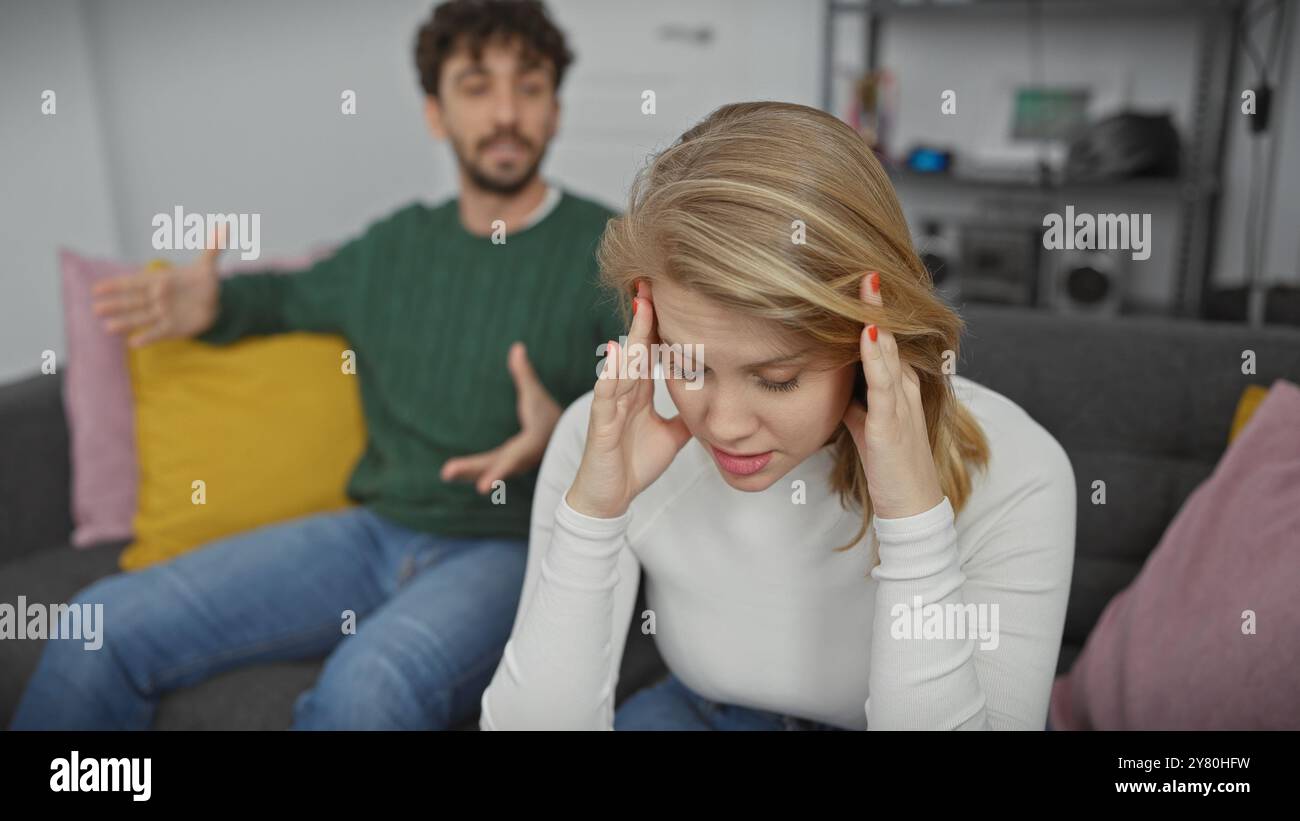 A distressed woman with a man gesturing in a blurry background ...