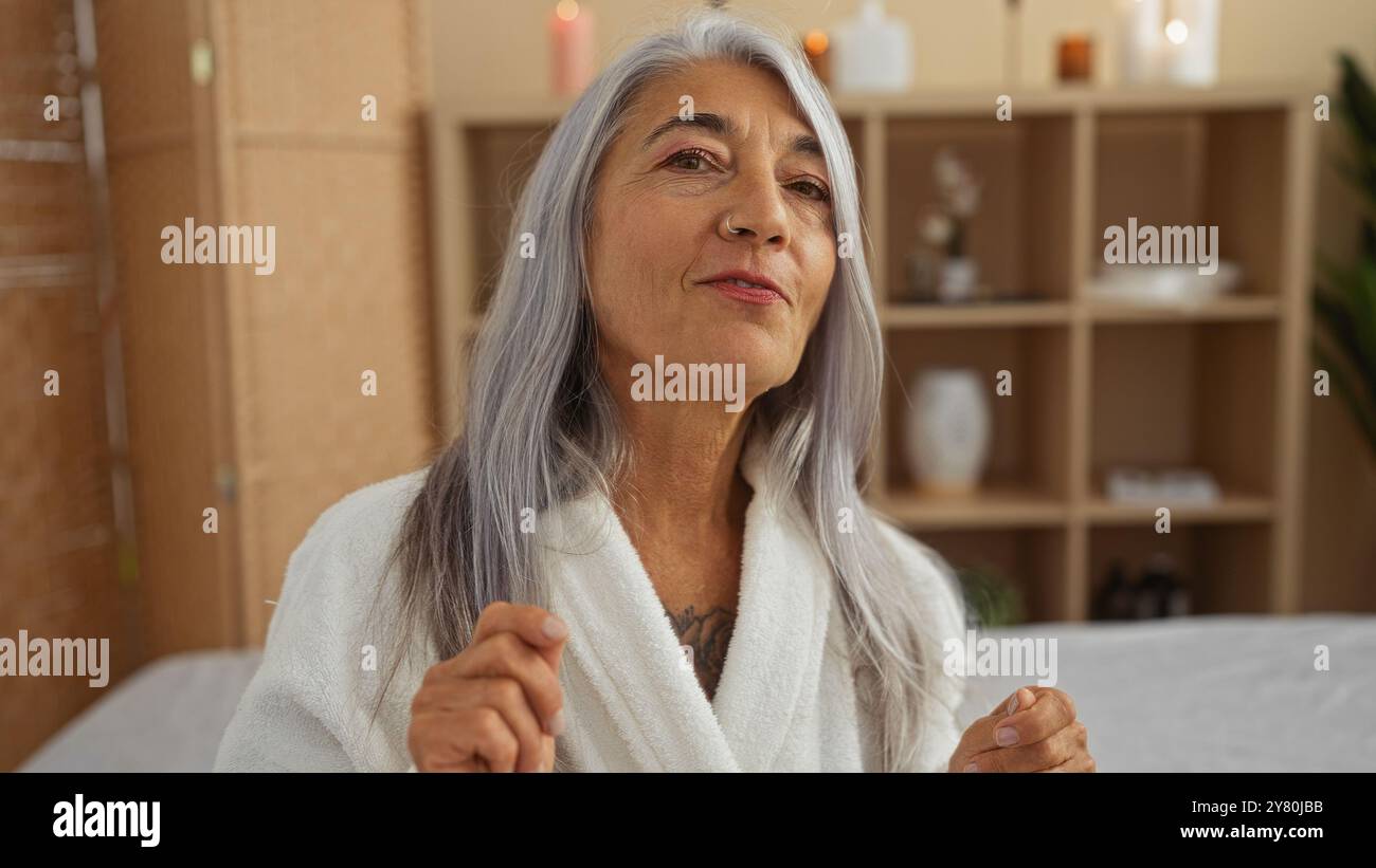 Mature woman with grey hair in a spa room enjoying a pampering session ...