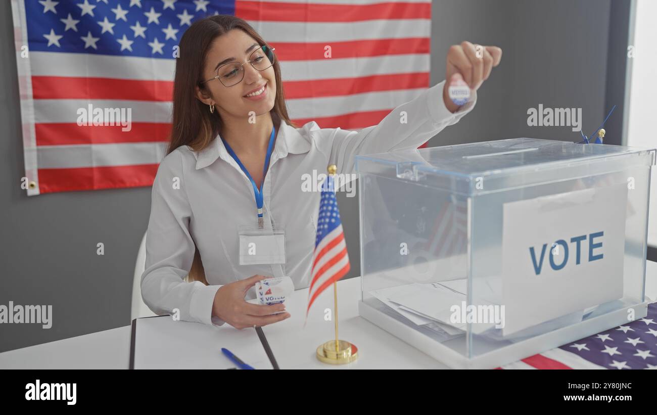 A young hispanic woman smiles as she casts a ballot at an american ...
