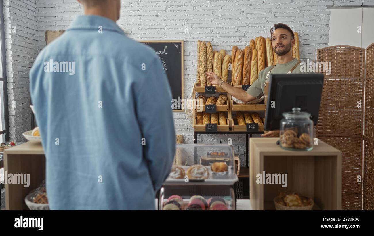 Baker serving man in a bakery shop interior with various breads behind ...
