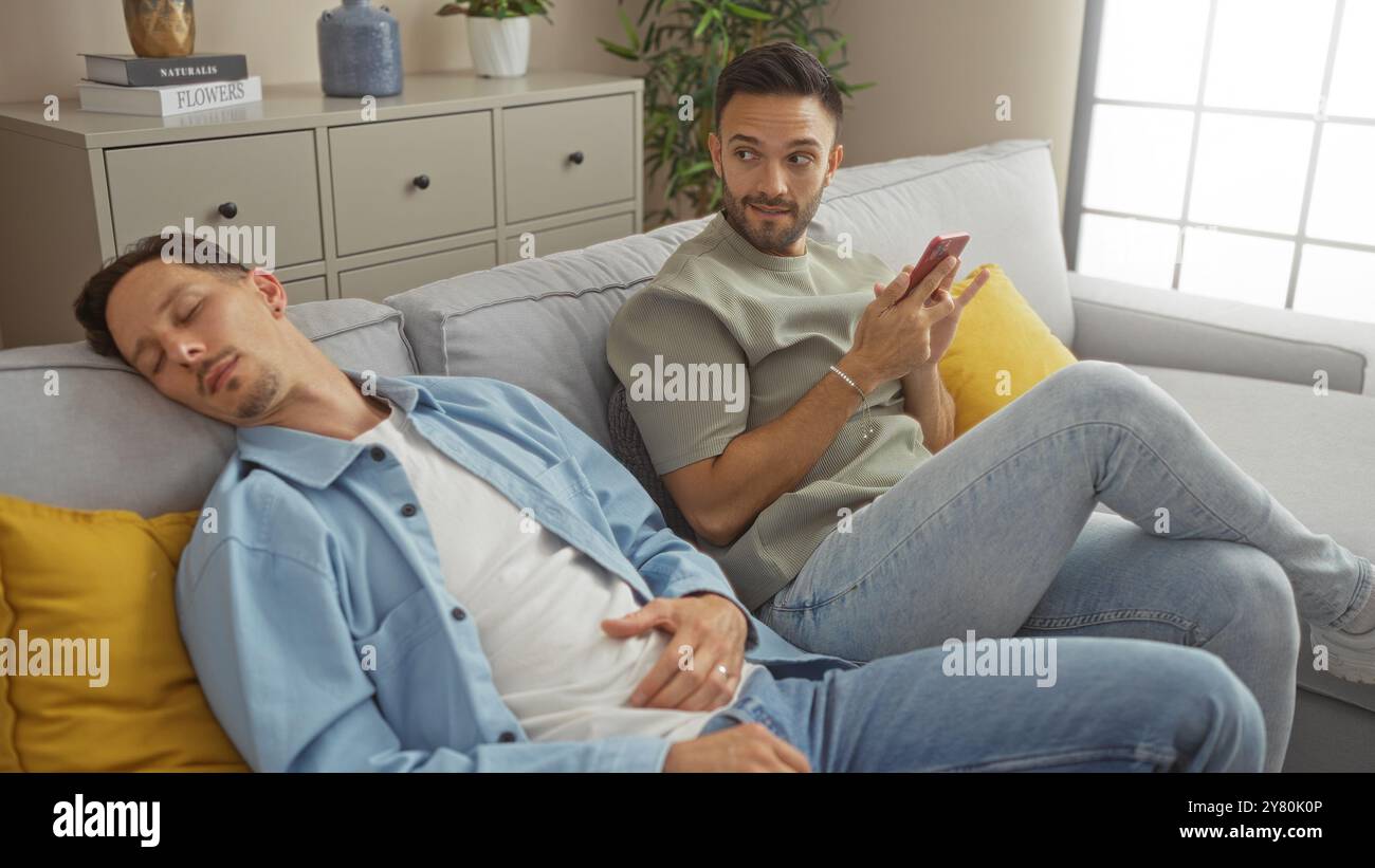 Two men, a loving couple, relax together at home, with one man sleeping ...