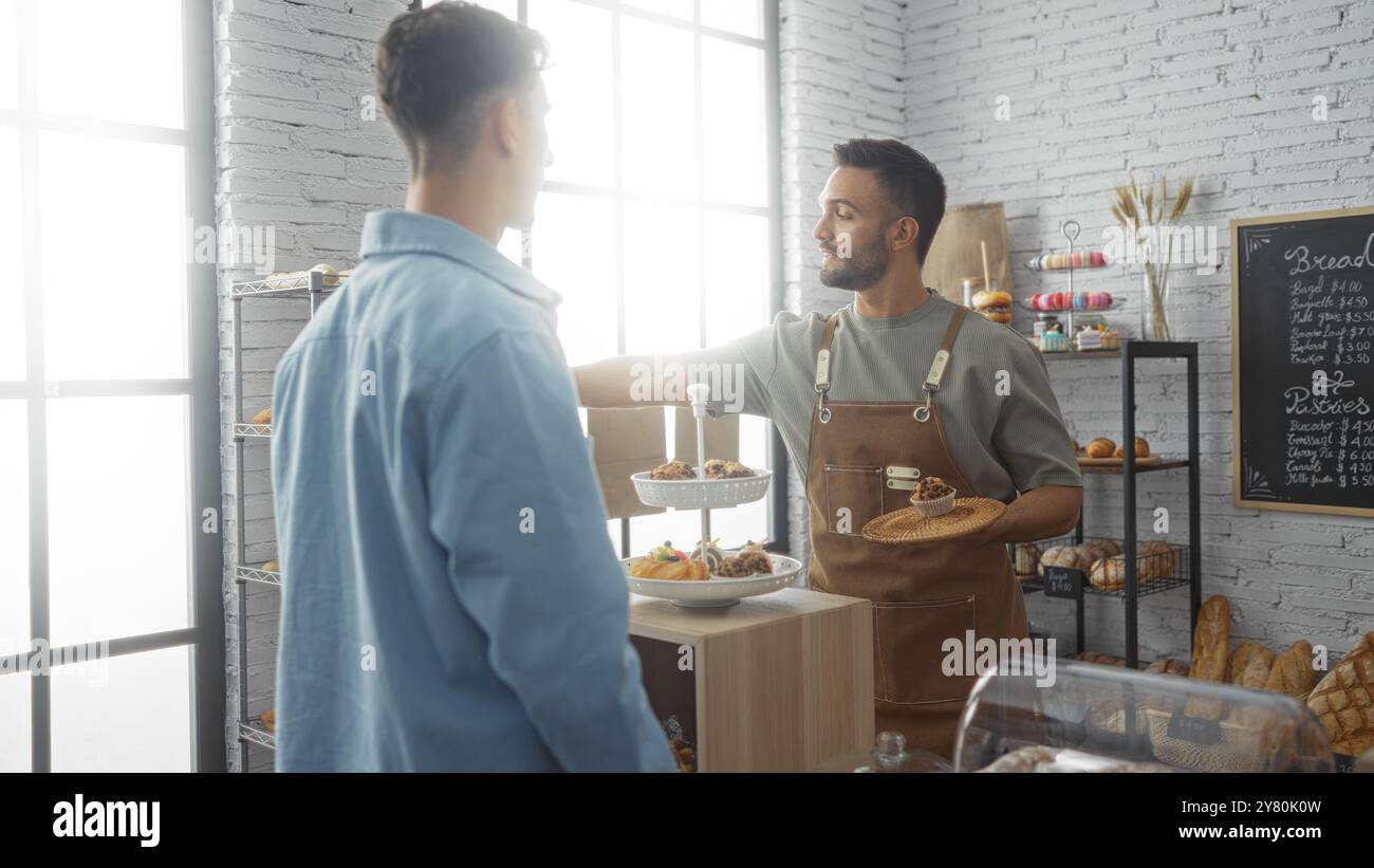 Man talking to a baker in a cozy bakery shop interior with pastries on ... Man talking to a baker in a cozy bakery shop interior with pastries on ...